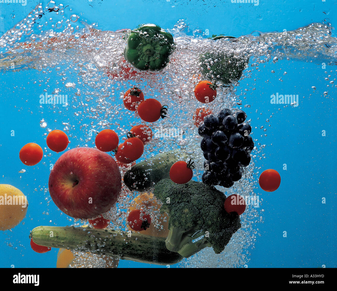 Fruits and vegetables dropped into the pool of water Stock Photo - Alamy