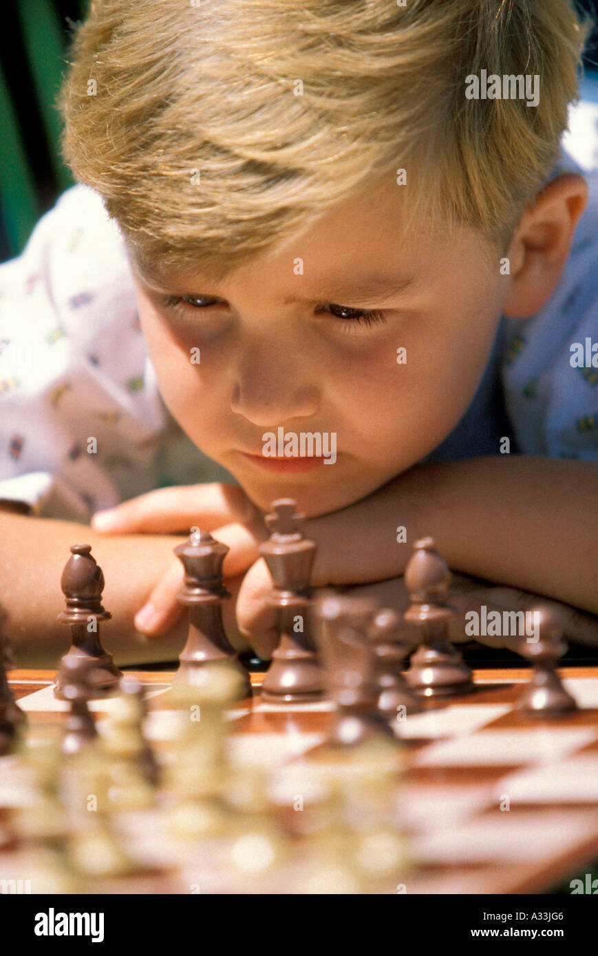 Boy playing chess MR671 Stock Photo - Alamy