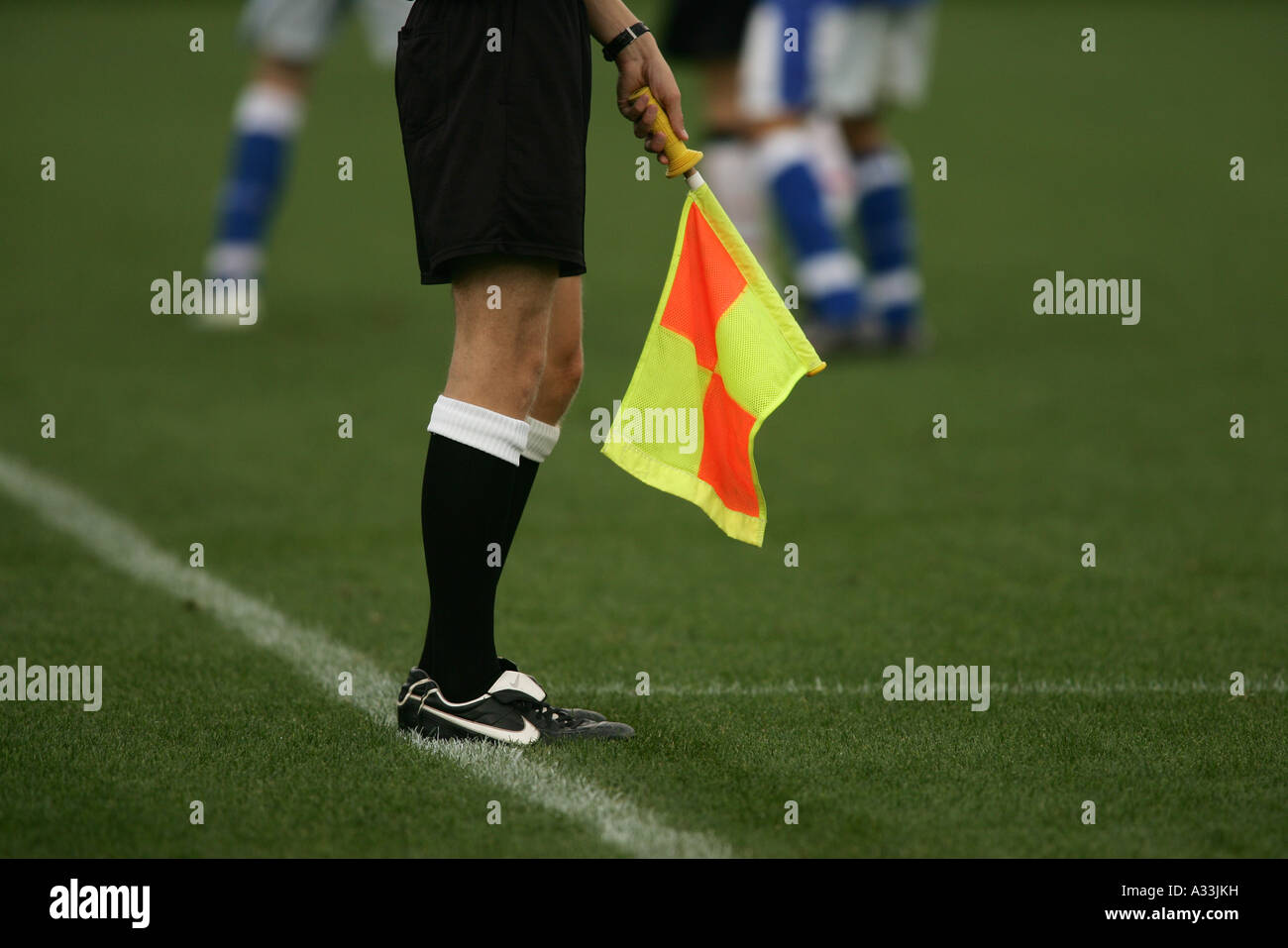 linesman stands with flag down during a football match Stock Photo - Alamy