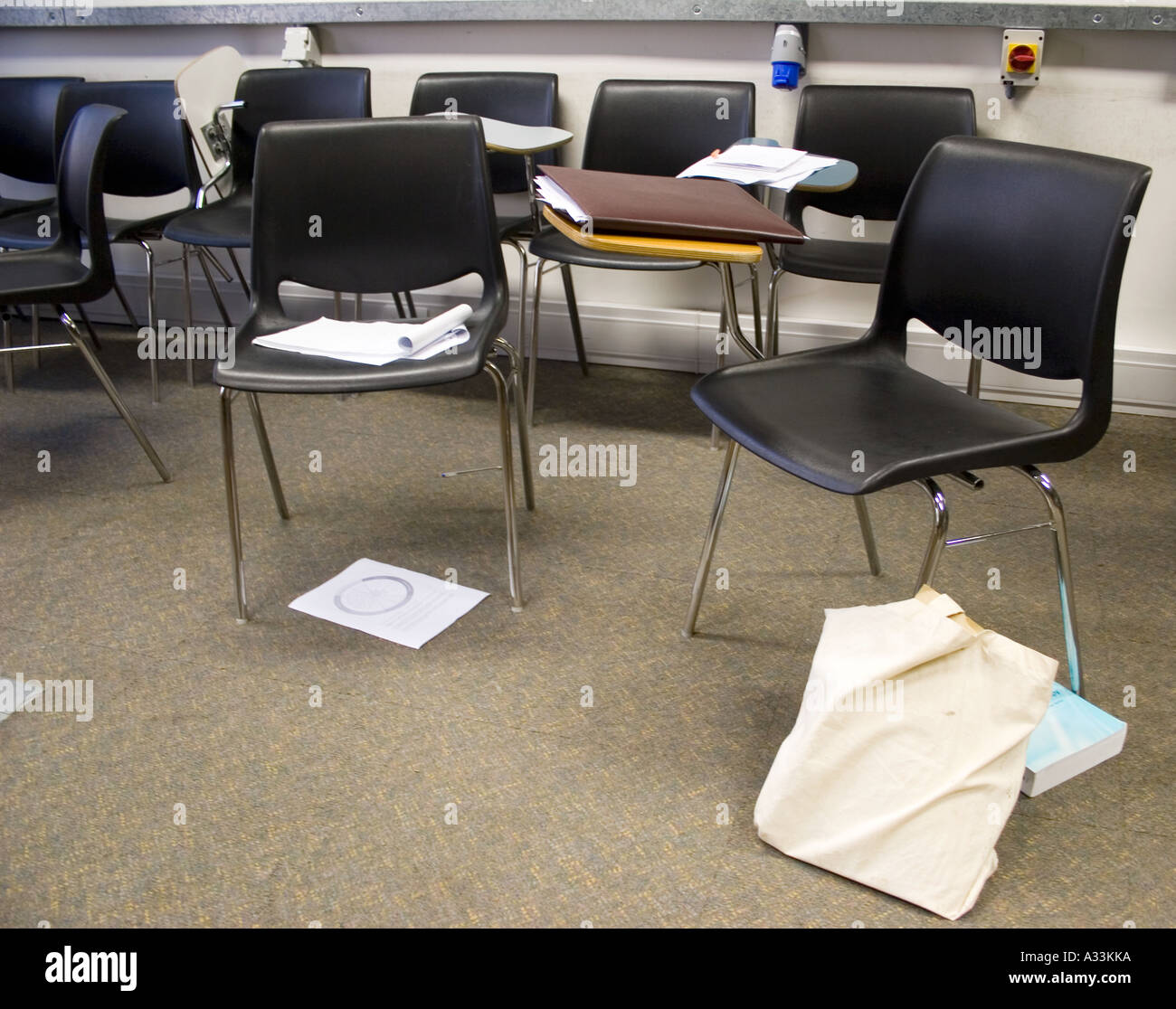 Empty untidy classroom with books on floor and seats. University of ...