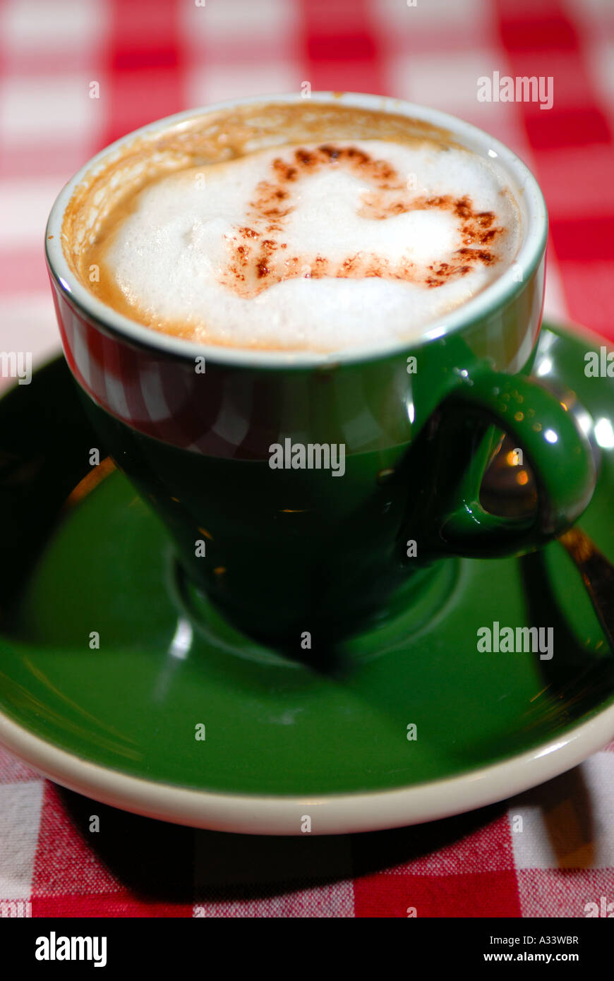 Cup of italien cappucino coffee with a love heart upright portrait shot ...