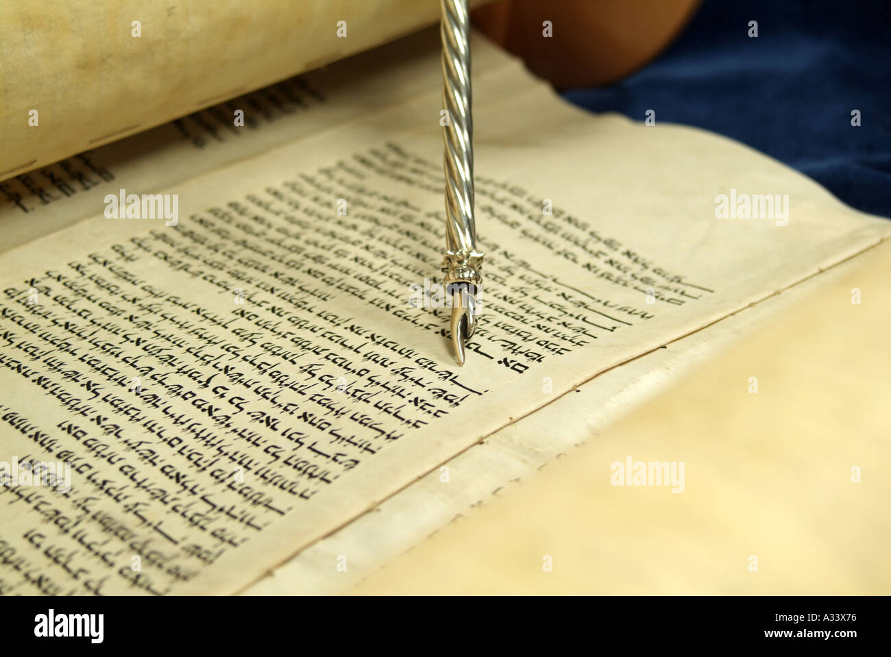 Hebrew Torah scroll with silver yad pointing to Hebrew script Stock ...