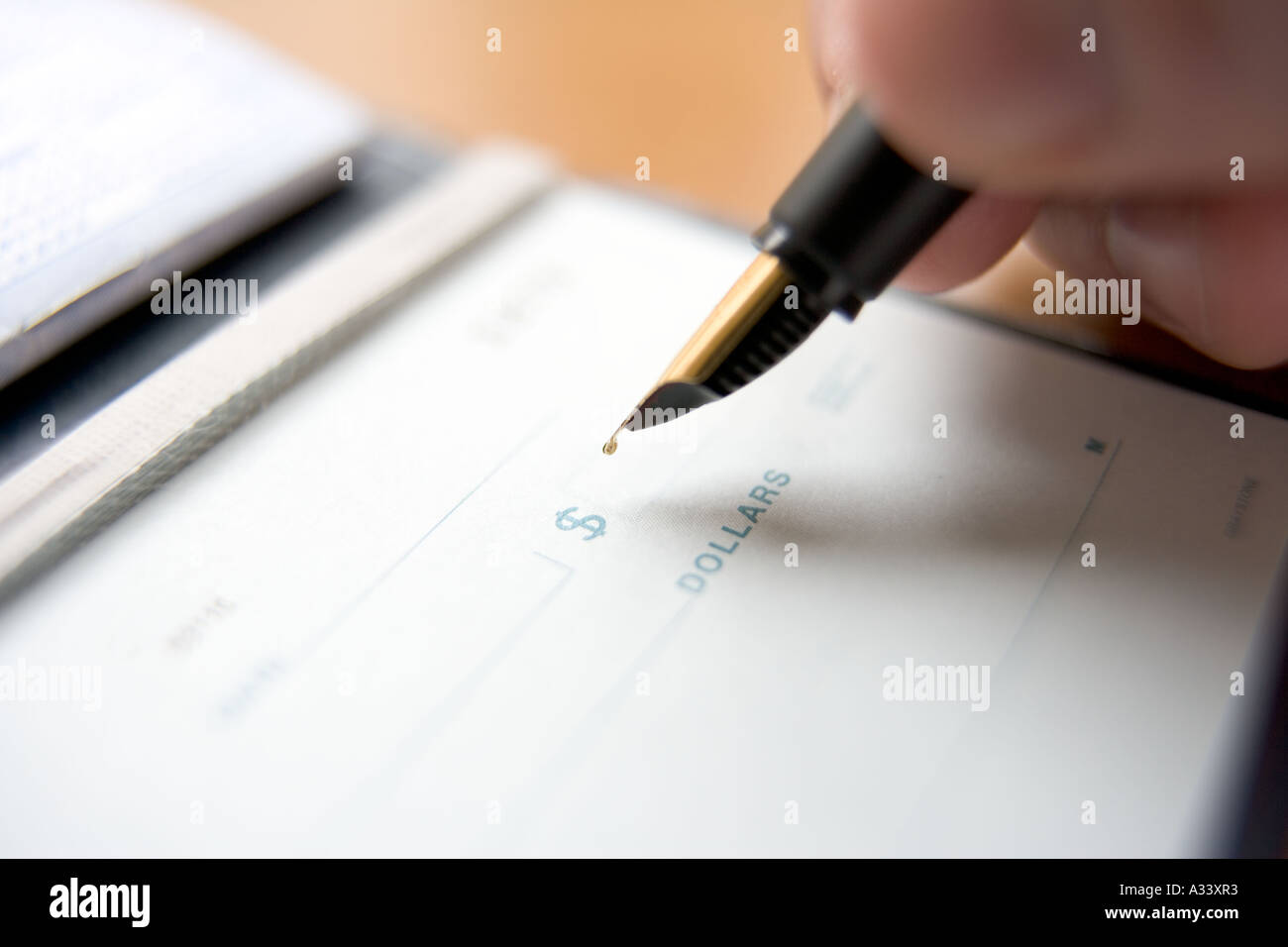 Writing a check - close up Stock Photo - Alamy