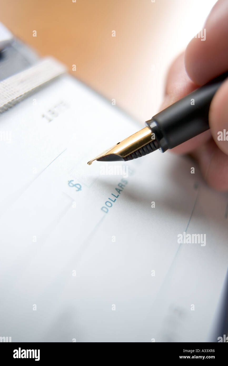 Writing a check - close up Stock Photo - Alamy