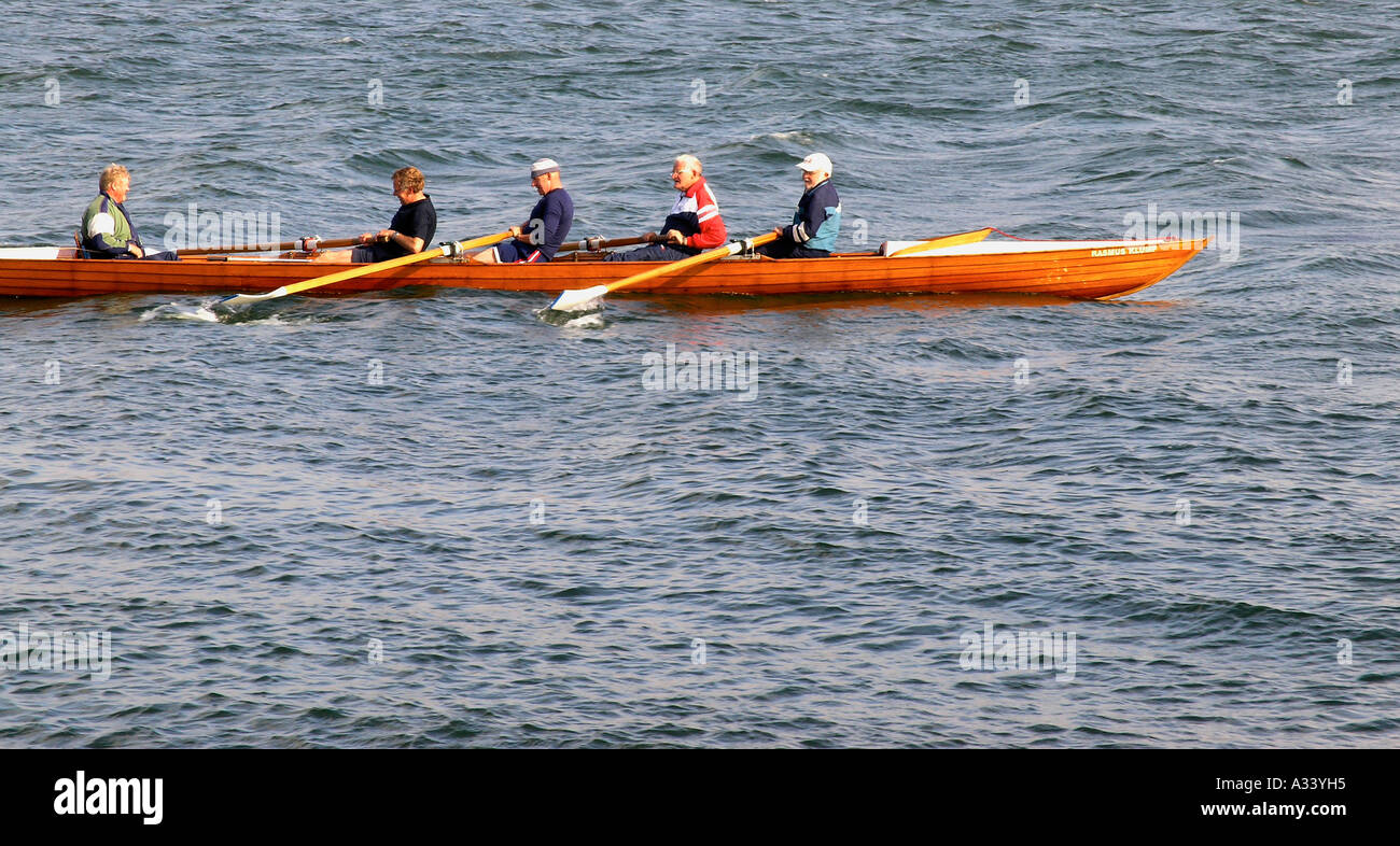 a group of seniors getting a good workout in their rowboat Stock Photo ...