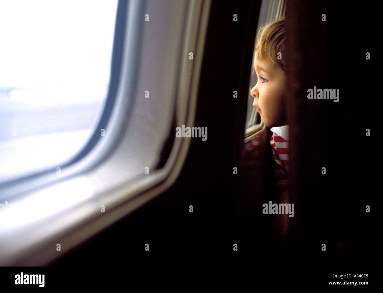 Boy looking through Airplane Window Stock Photo - Alamy