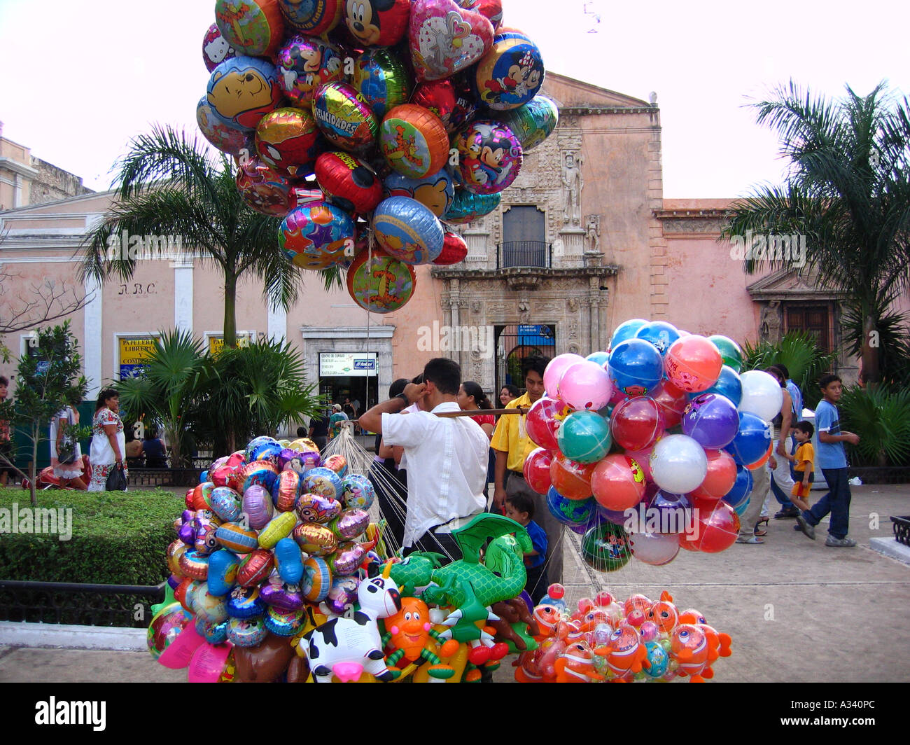 man selling colourful balloons in the main plaza, Merida, Yucatan ...
