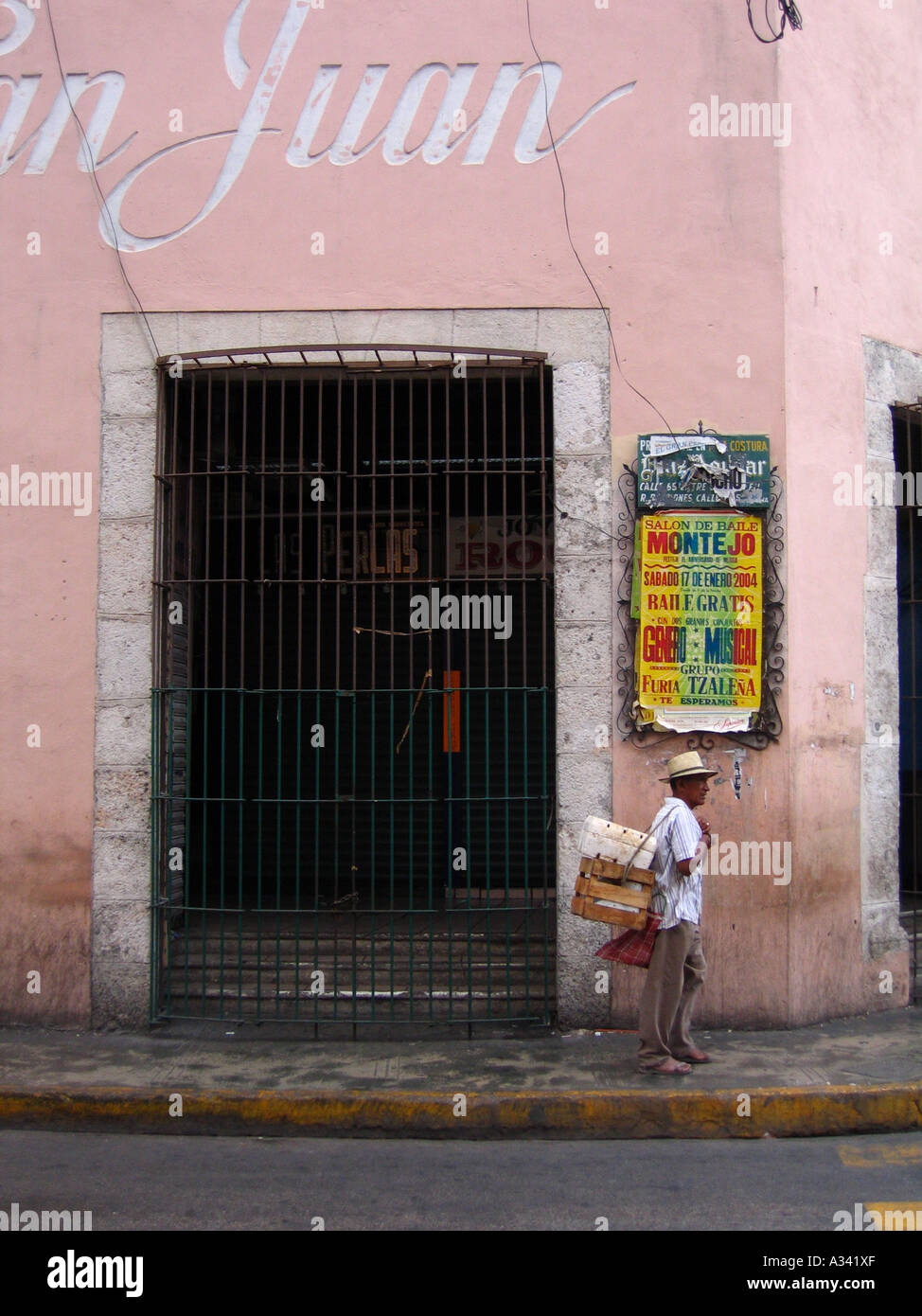 man walking past poster in the street, Merida, Yucatan, Mexico Stock ...