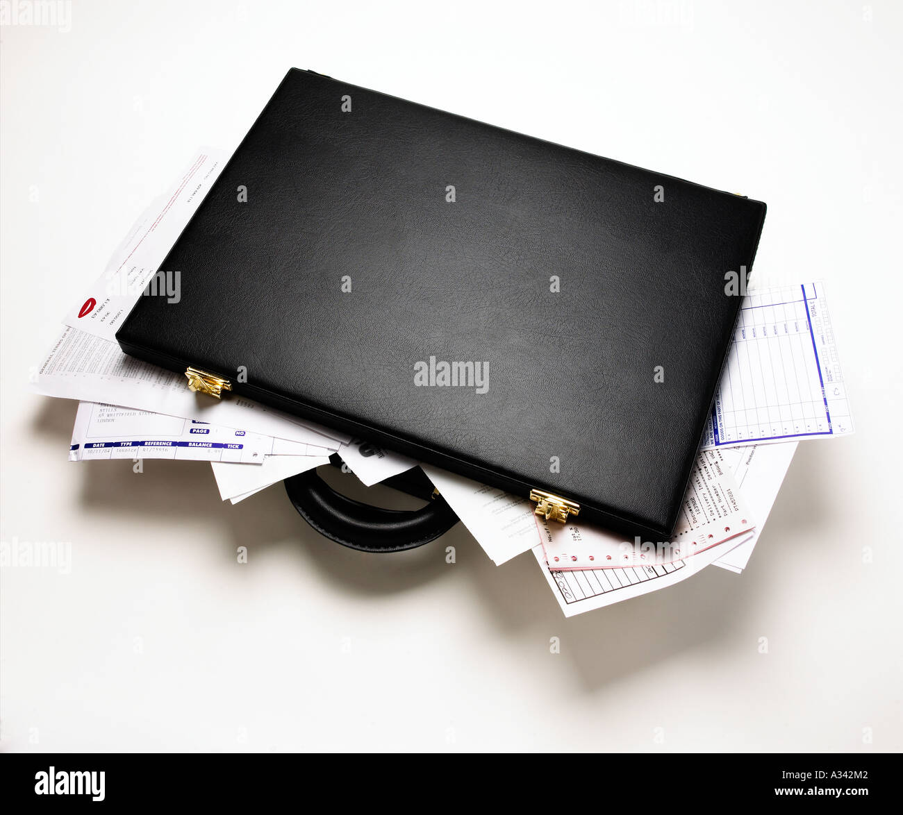 closed black briefcase overflowing with paper bills Stock Photo - Alamy