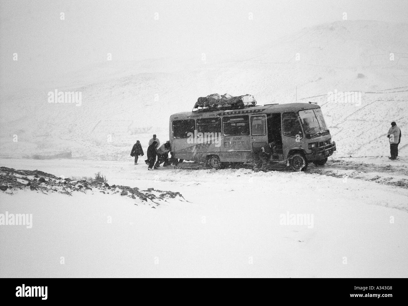People pushing uphill a stranded bus in snow storm near Potosi in ...