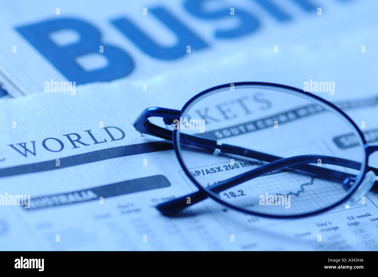 business newspaper with world market charts and glasses on top Stock ...