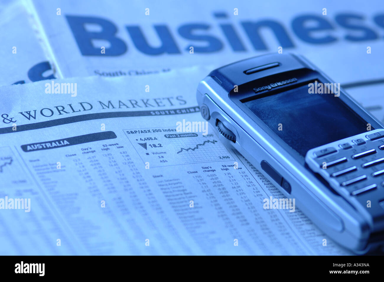 business newspaper with mobile phone, pda Stock Photo - Alamy