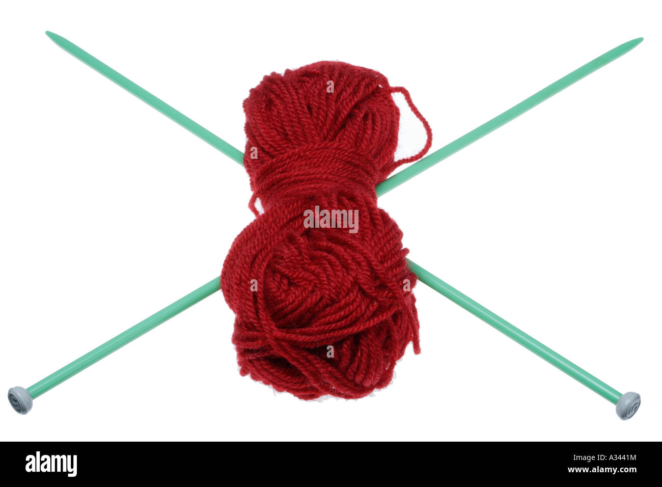 A pair of knitting needles and red wool Stock Photo - Alamy