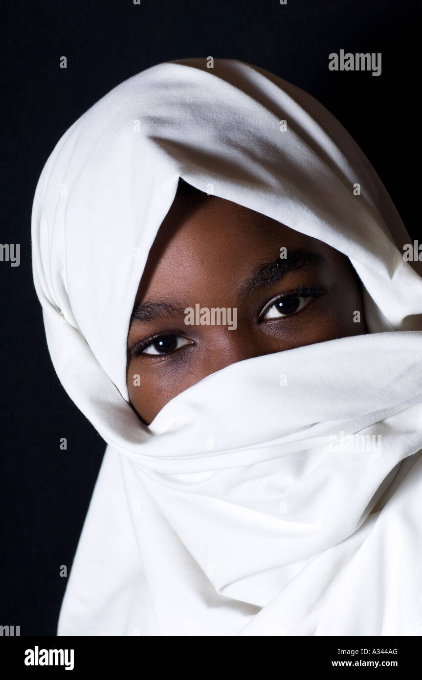 Portrait of a young African Arab in white on a black background Stock ...