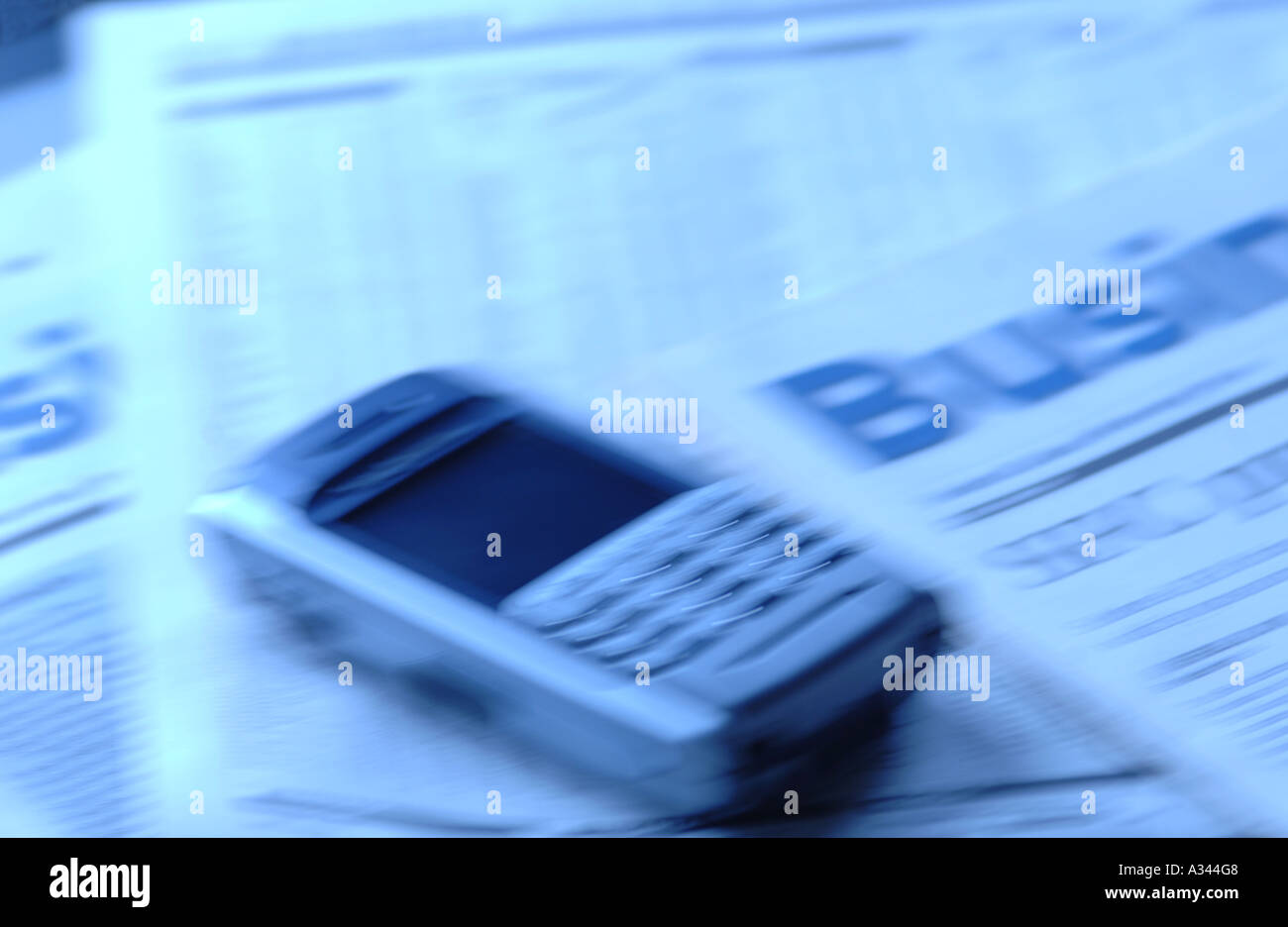 business newspaper with mobile phone, pda, blurred, zooming Stock Photo ...