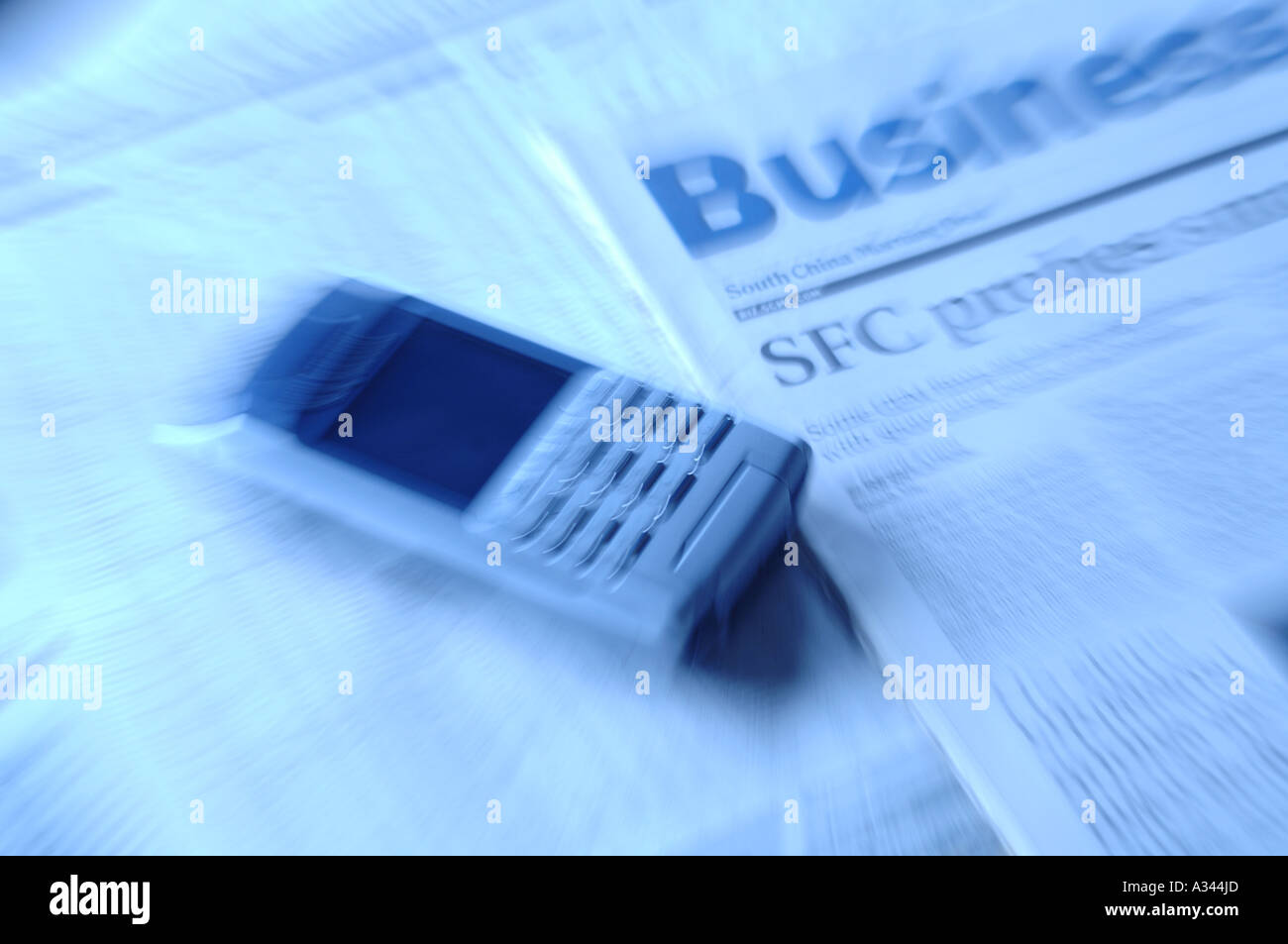 business newspaper with mobile phone, pda, blurred, zooming Stock Photo ...