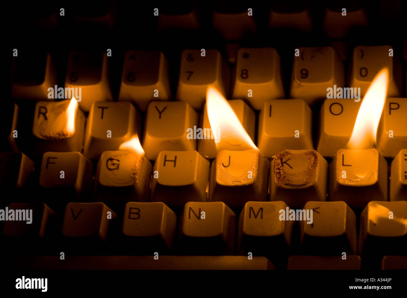Computer keyboard burning Stock Photo - Alamy