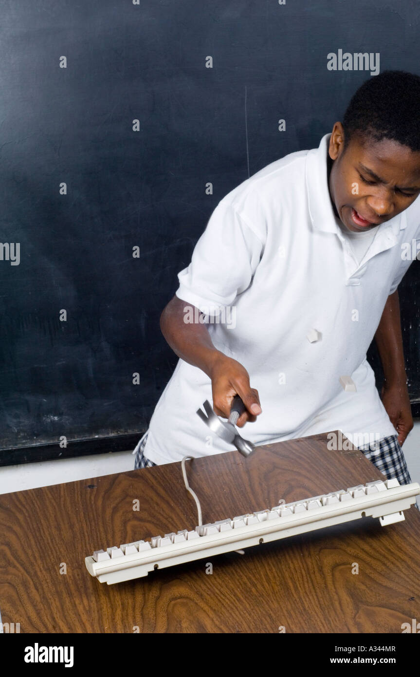 Student breaking a keyboard with a hammer in a classroom Stock Photo ...