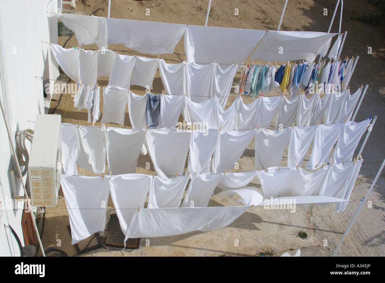 Greece greek island of Naxos Washing out on the line drying in hot sun ...