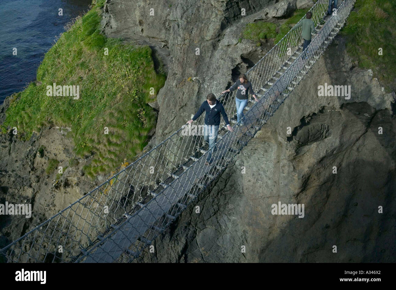Walking the Carrick-a-Rede rope bridge Co Antrim Northern Ireland Stock ...