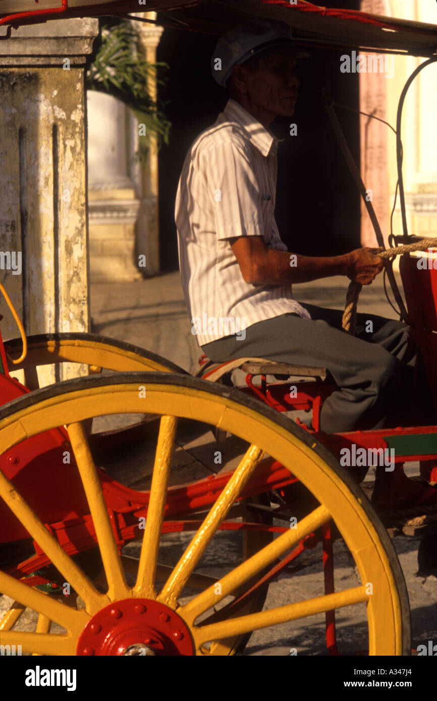 A man drives his horse driven carriage "Kalesa," in Manila, Philippines ...