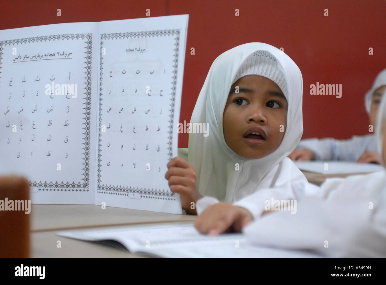 Religion to study the koran studying hi-res stock photography and ...