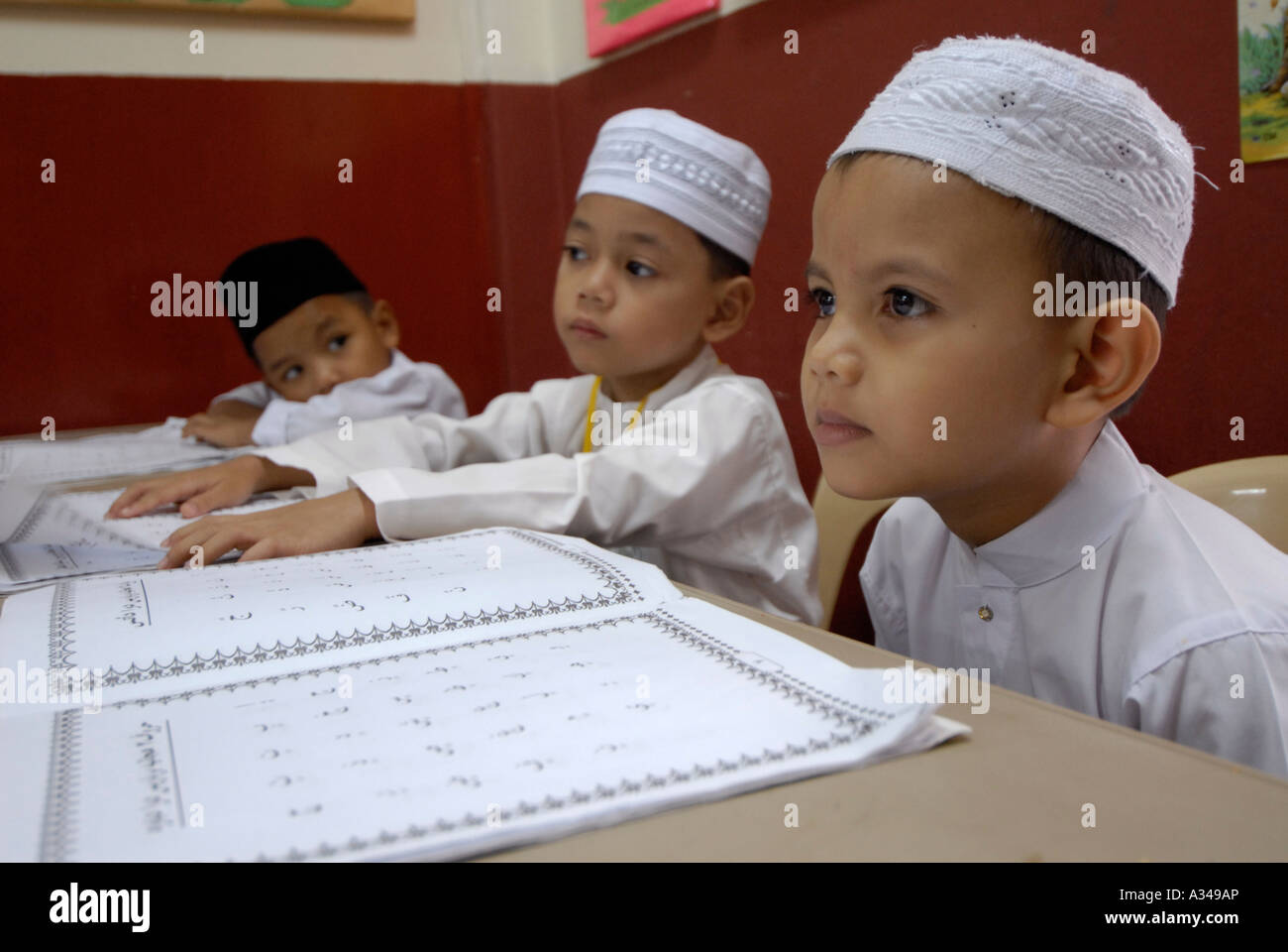 Primary one and kindergarten students studying a simplified version of ...