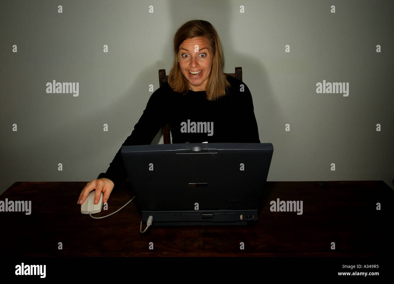 Woman pulling face and desk hi-res stock photography and images - Alamy