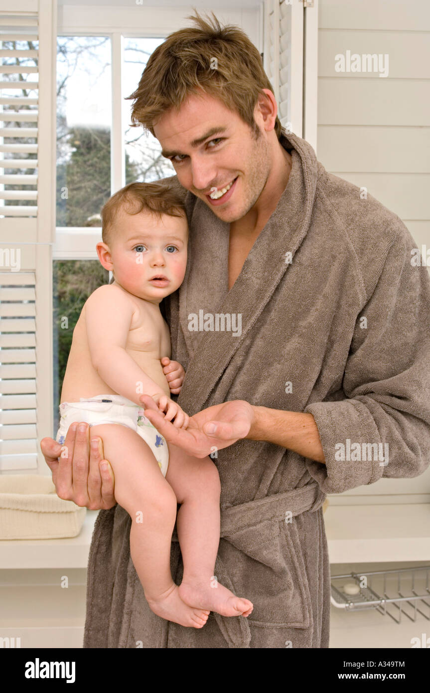 Young smiling man with baby Stock Photo - Alamy