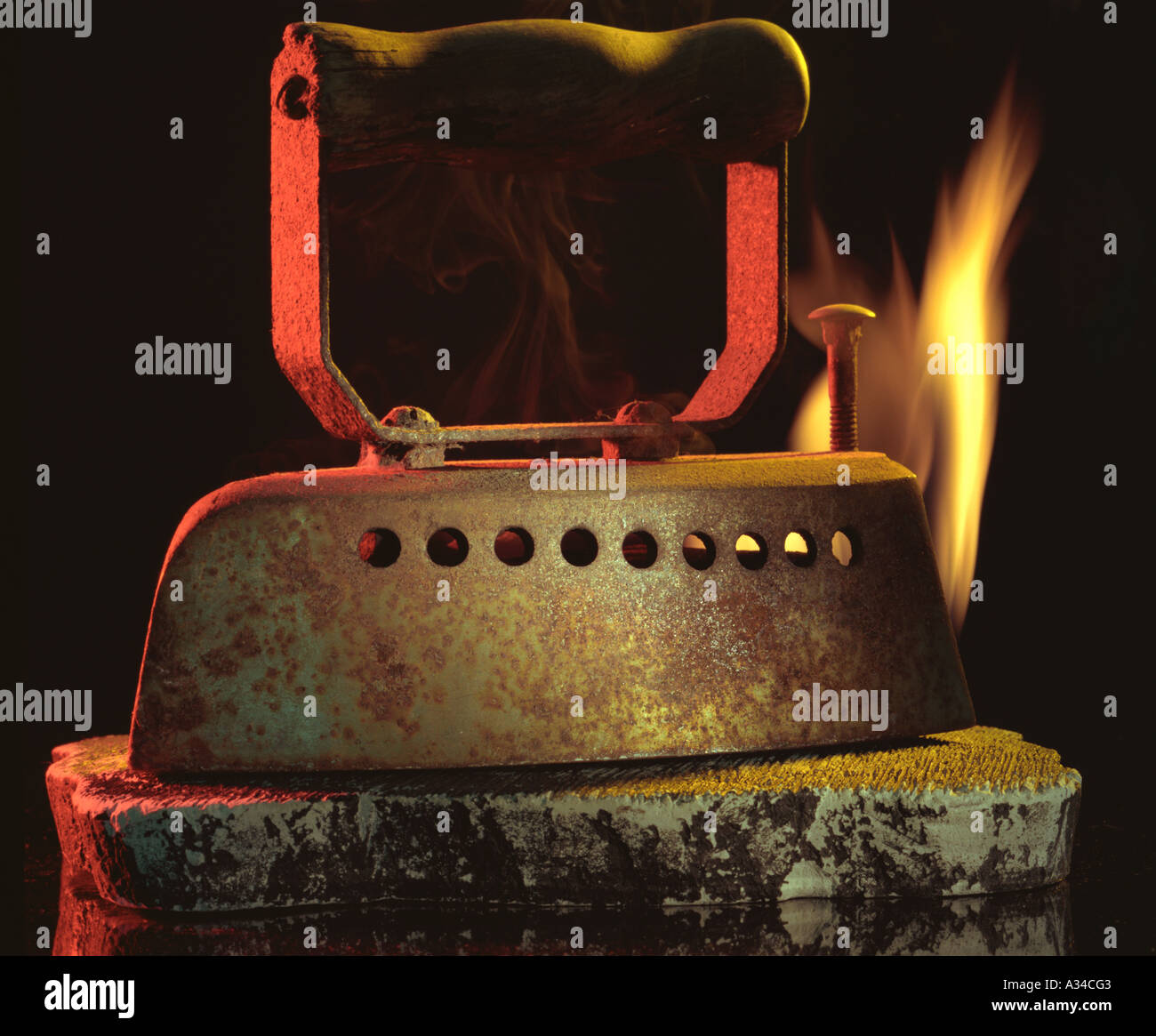 An antique iron is shot with flames coming out of it Stock Photo - Alamy