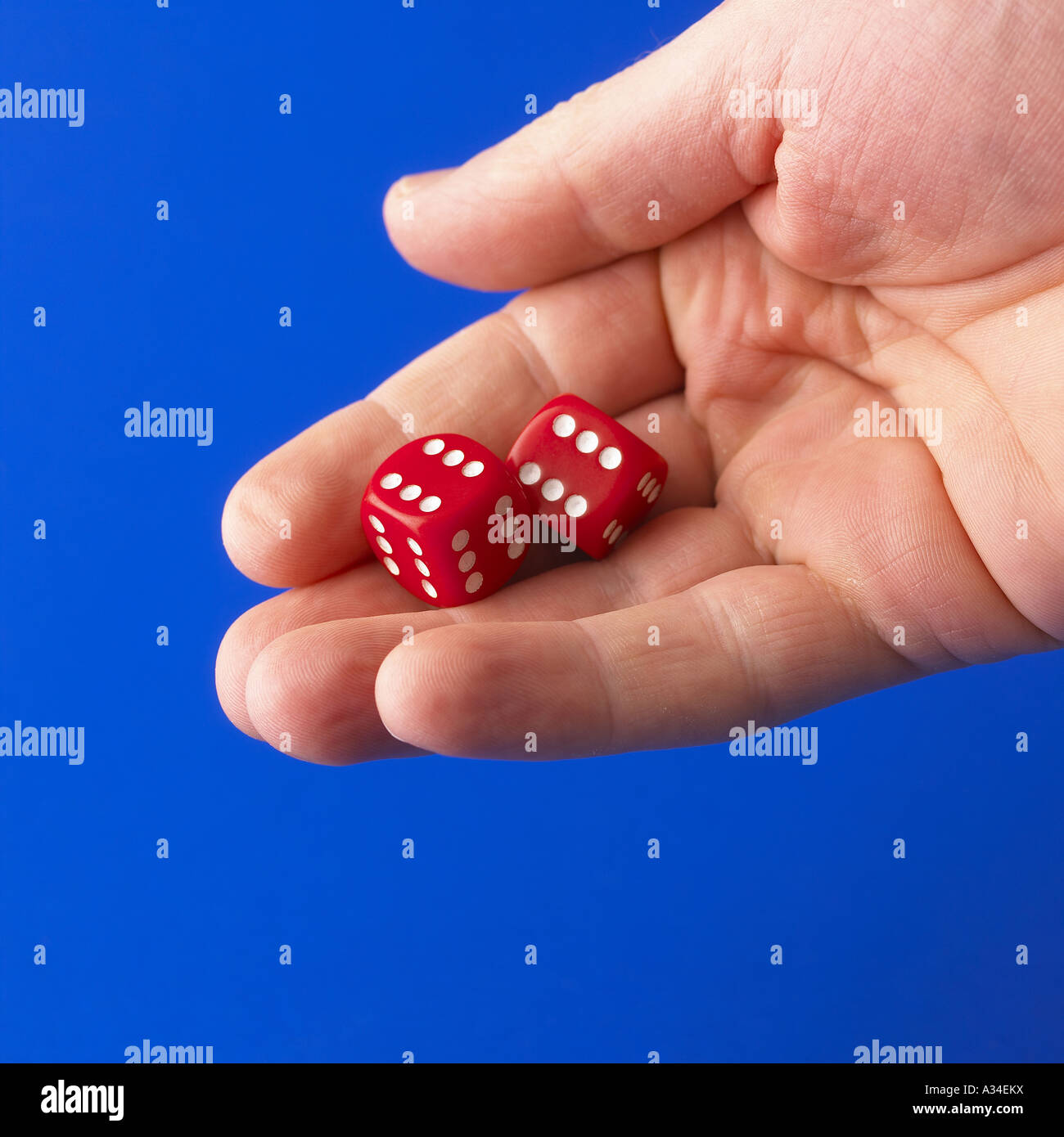 two red dice in hand with six on all sides of dice Stock Photo - Alamy