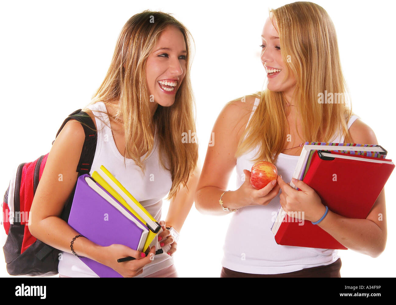 Two blond high school senior girls with text books hanging out laughing ...