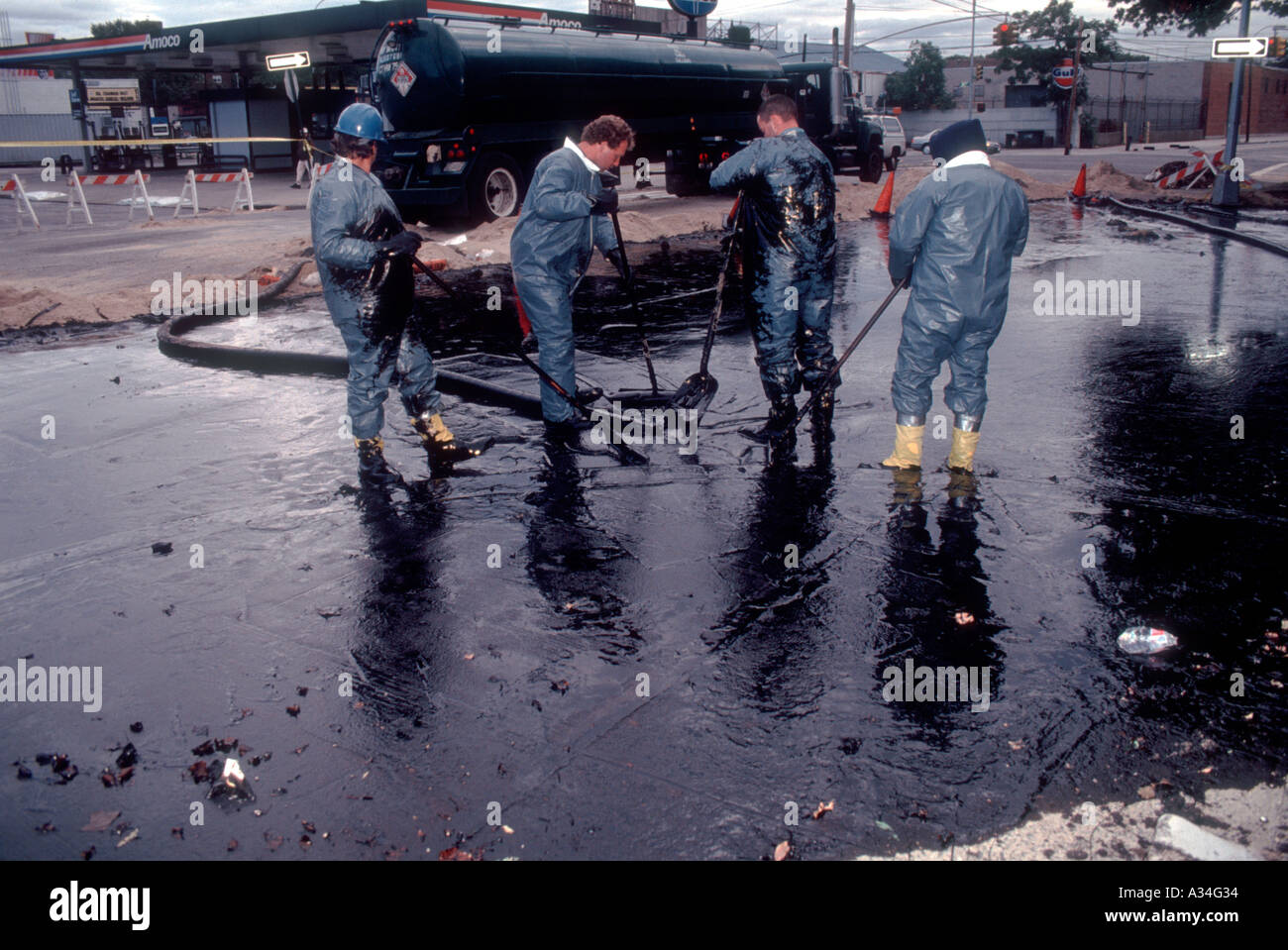 Workers clean up and contain an oil spill in Long Island City Queens An ...