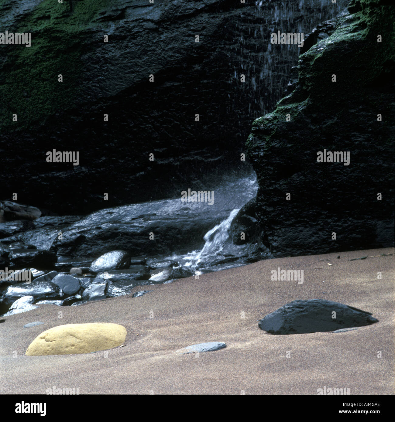 Rock and pebbles emerging through beach sand Saltwick Bay North ...