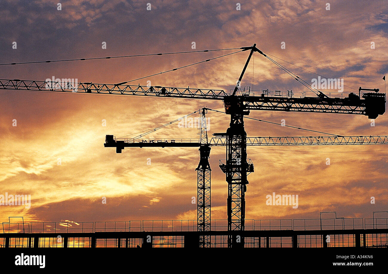 Two tower cranes standing parallel to each other Stock Photo - Alamy