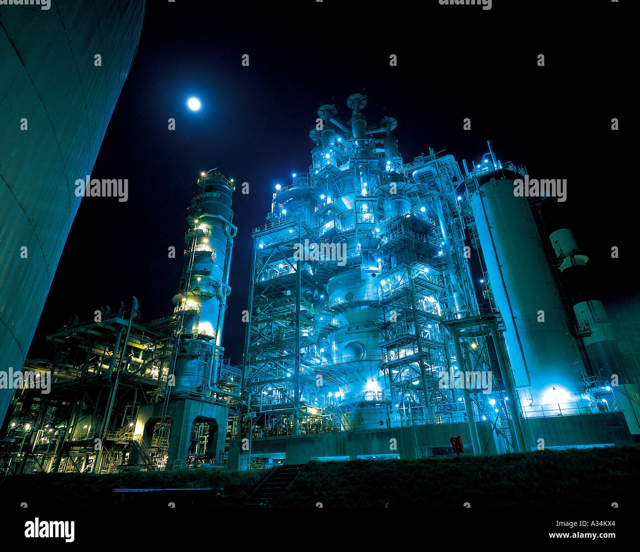 The factory lit up at night Stock Photo - Alamy