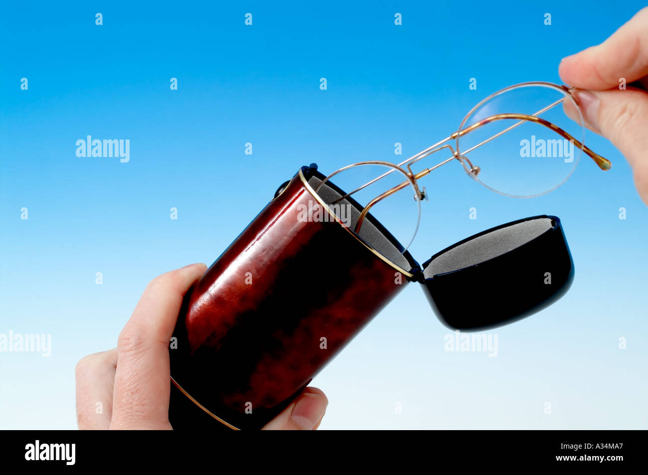 Hand taking spectacles out of a case Stock Photo - Alamy