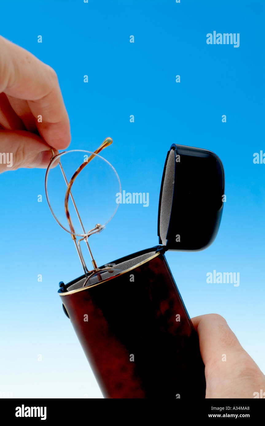 Hand taking spectacles out of a case Stock Photo - Alamy