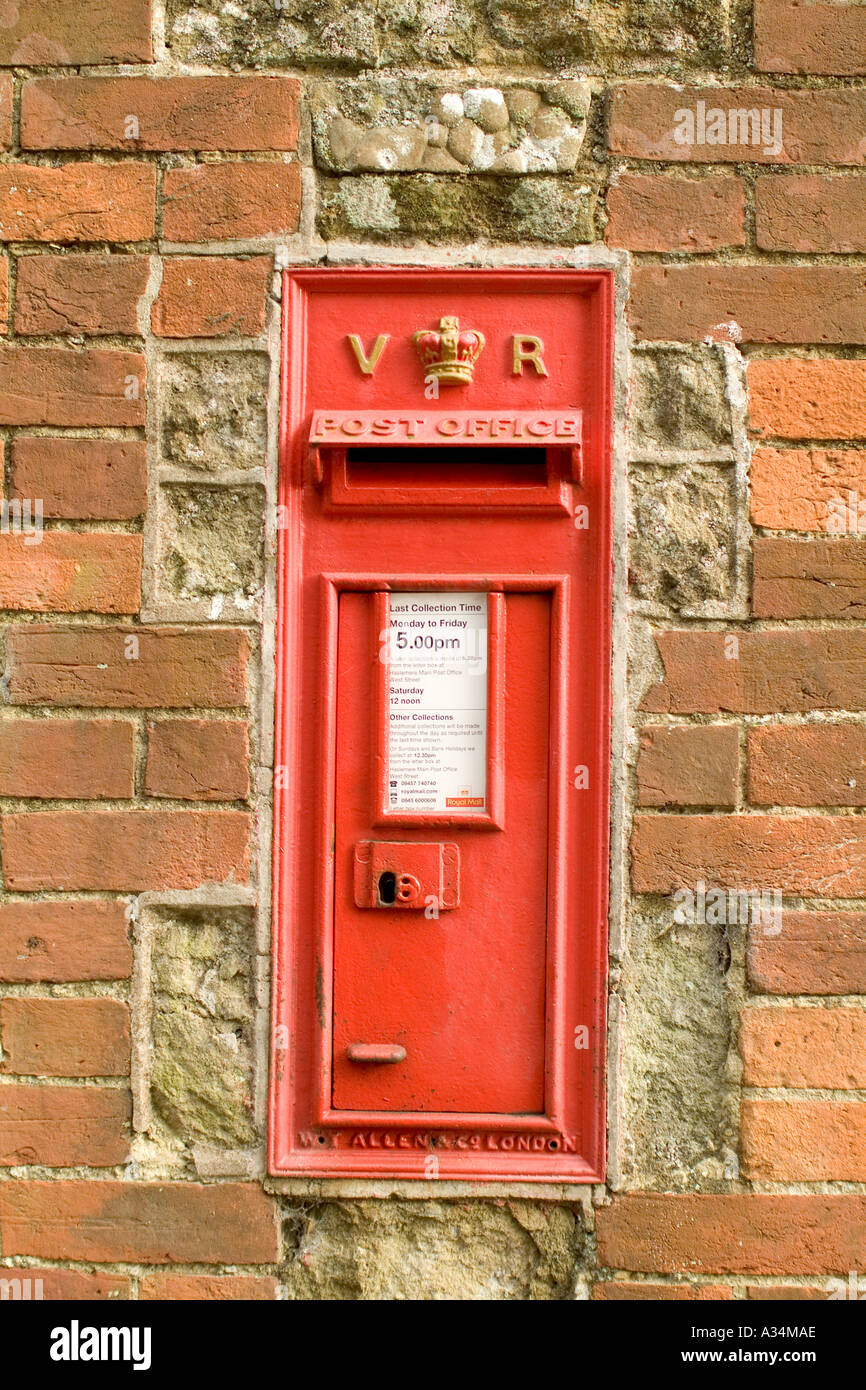 Red letter box set into the wall of a house UK Stock Photo - Alamy