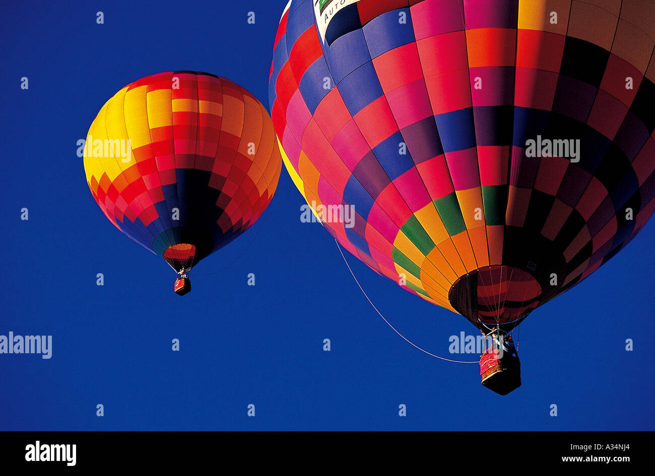 Two colorful hot air balloons floating in the air side by side Stock ...