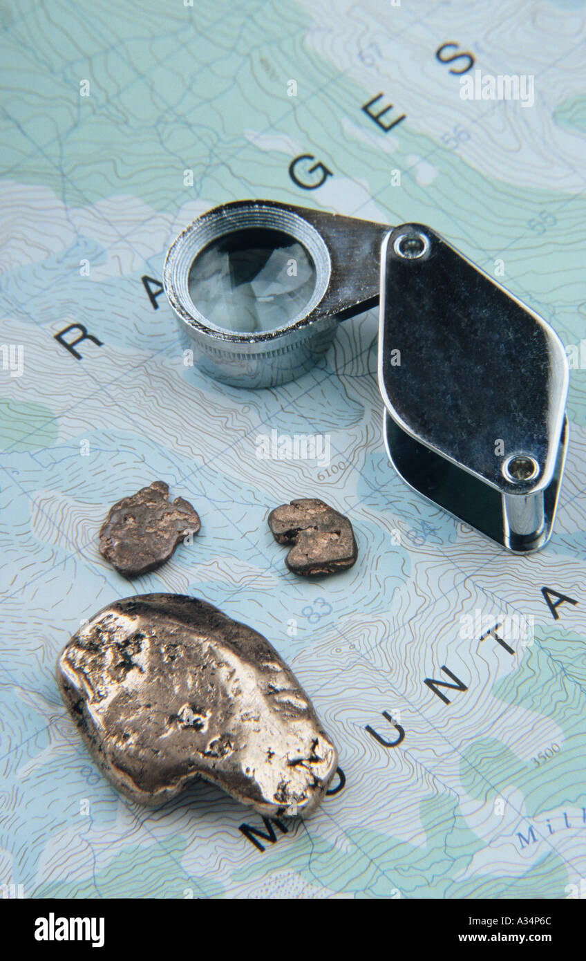 Mining concept with nuggets map and magnifier Stock Photo - Alamy