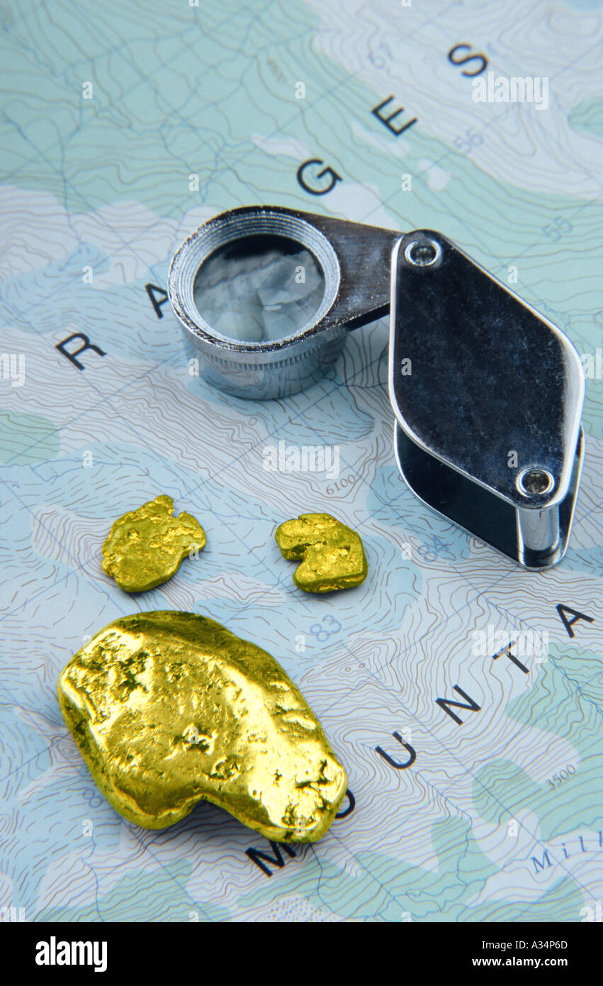 Mining concept of gold nugget map and magnifier Stock Photo - Alamy