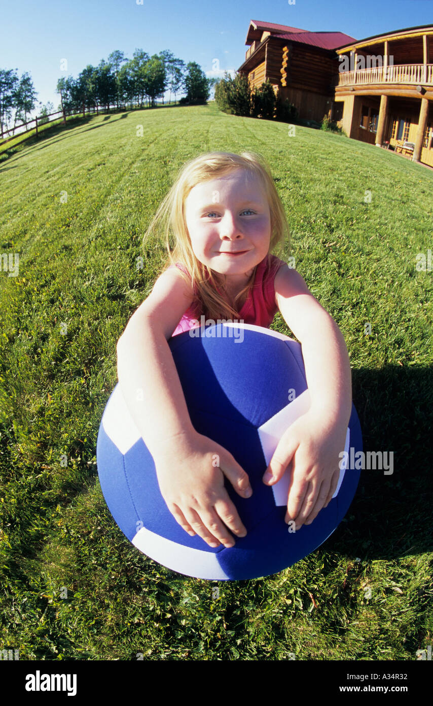 Young girl playing on grass Smithers British Columbia Canada Stock ...