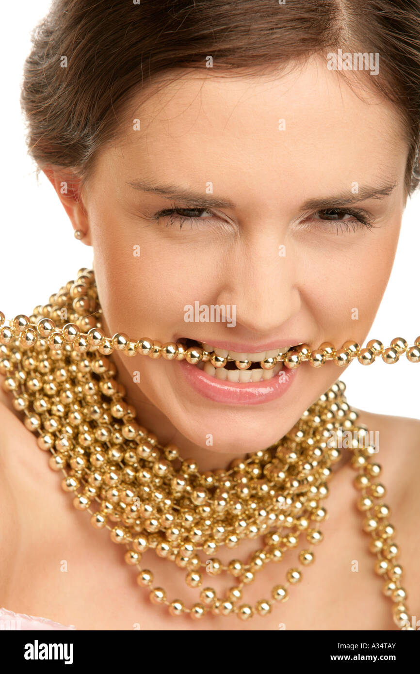 Young attractive woman biting necklace Stock Photo - Alamy