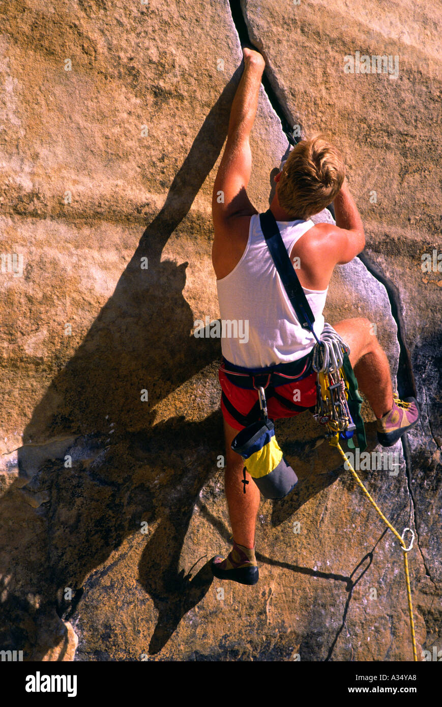 Young man rock climbing model released image Stock Photo - Alamy