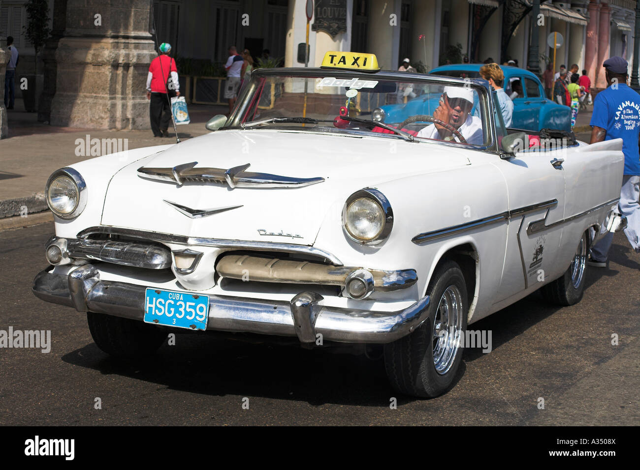 Dodge classic white taxi being driven by a driver speaking on a mobile ...