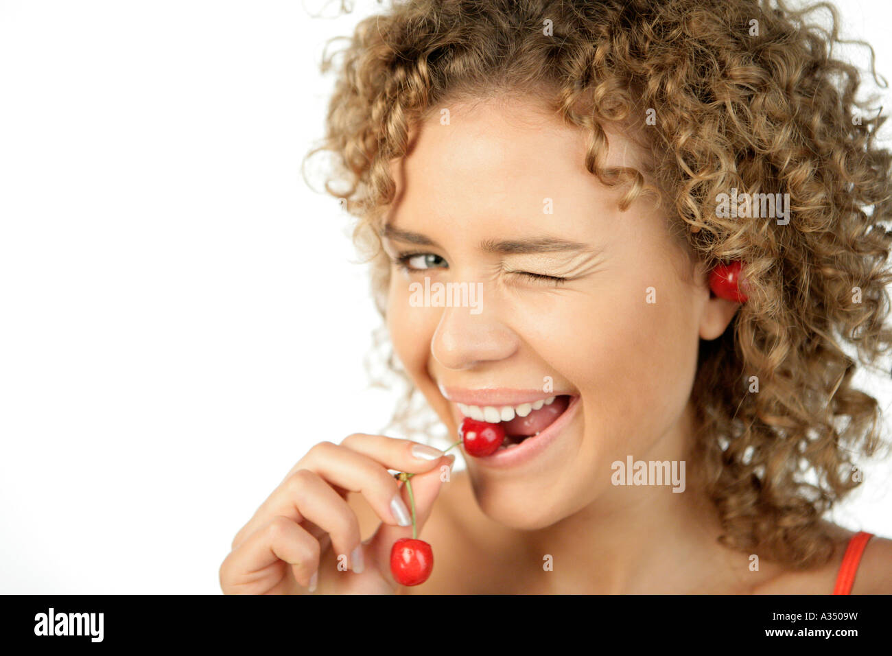 Young woman eating cherries Stock Photo - Alamy
