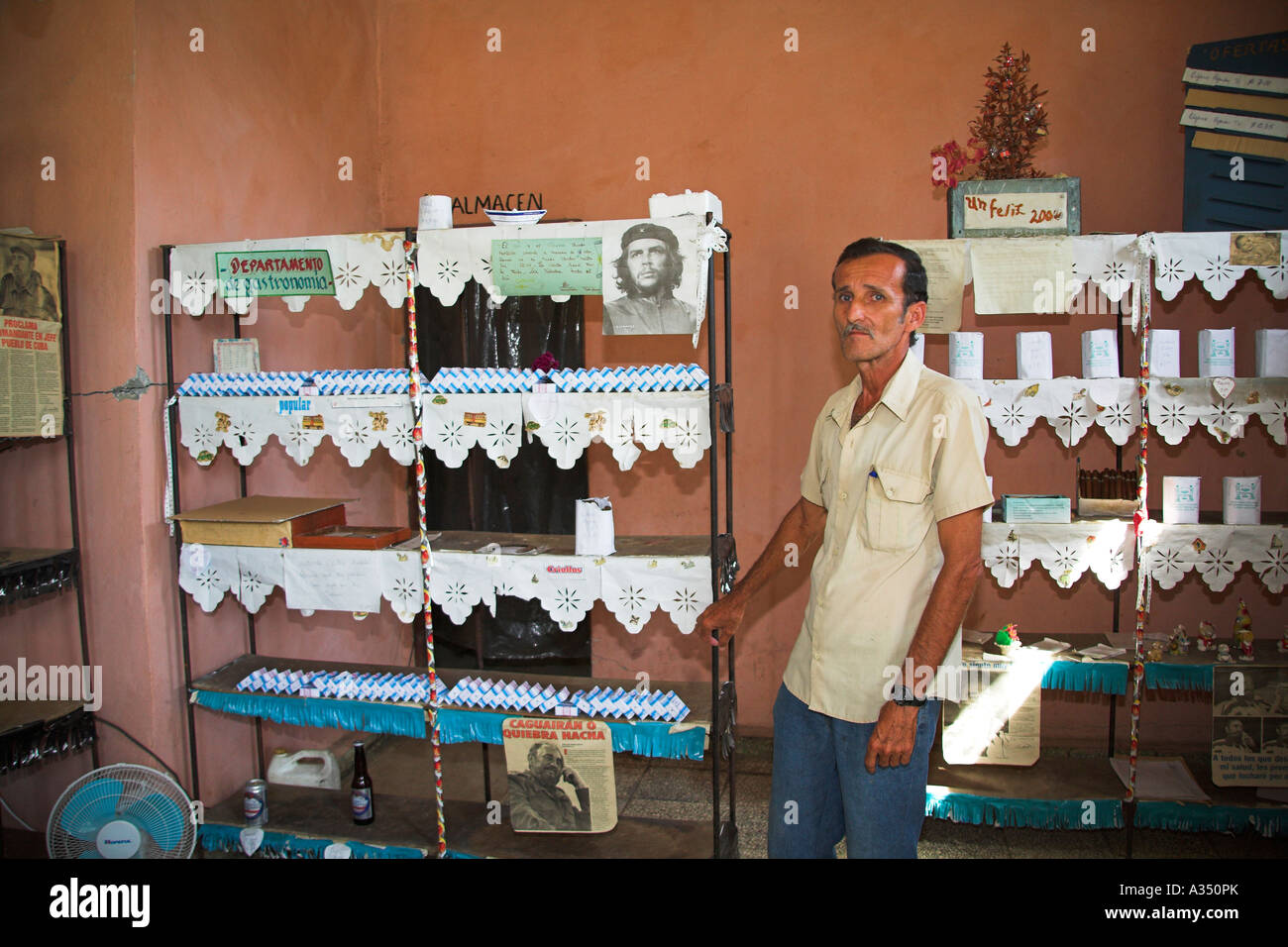Local man posing in a ration card shop, Camera Village near Santiago de ...