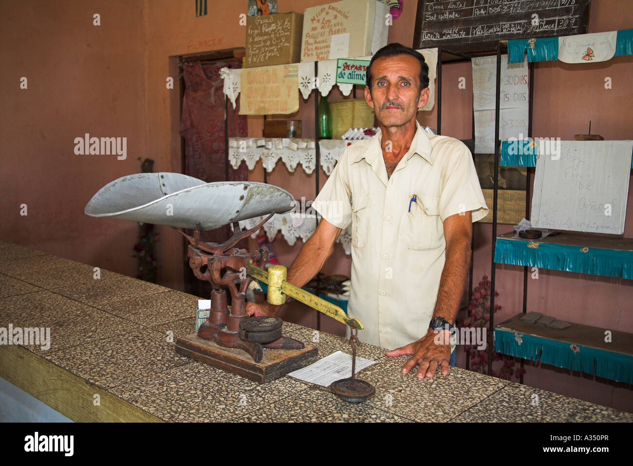 Local shopkeeper posing in a ration card shop, Camera Village near ...