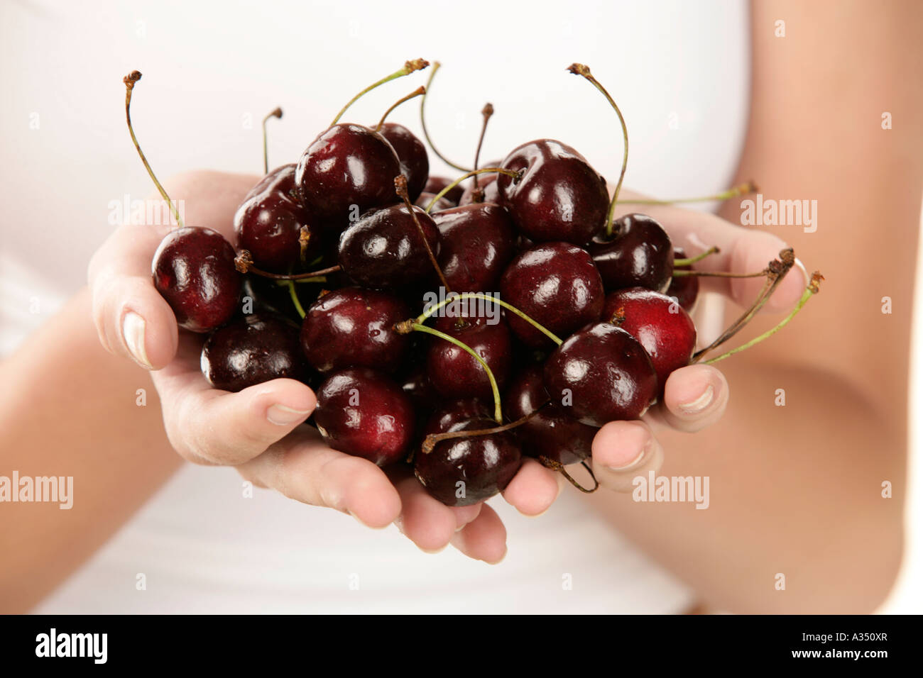 Woman's hands with cherries Stock Photo - Alamy